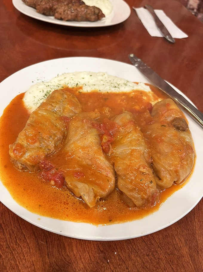 Stuffed cabbage rolls bathing in tomato sauce. These little packages contain more comfort than your favorite childhood blanket ever did.