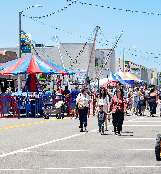 Summer festivals transform parking lots into wonderlands of bounce houses and funnel cakes&mdash;childhood joy with adult supervision.
