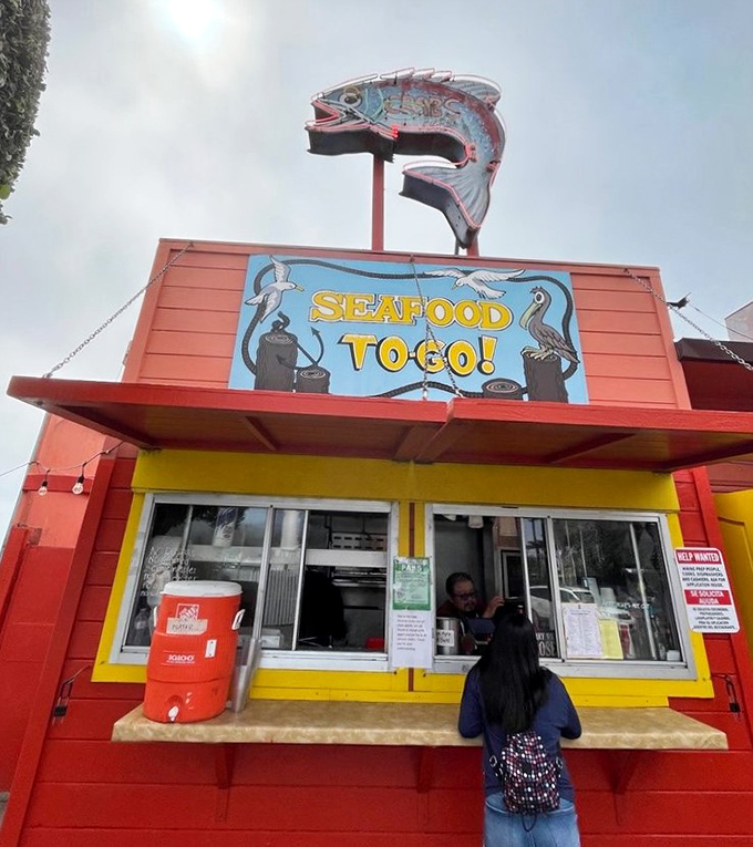The "Seafood To-Go" window, crowned with a giant fish sign, for those who can't wait for a table. Like a seafood ATM dispensing edible happiness to the impatient.