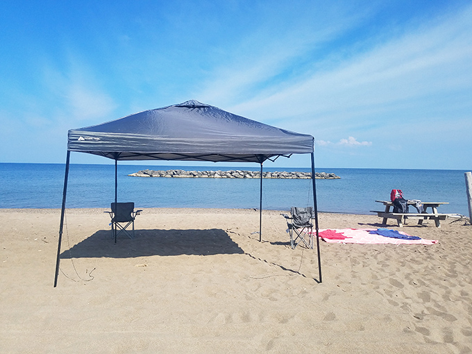 Beach day headquarters established with military precision&mdash;this canopy setup claims territory while providing shade that SPF 100 can't match.
