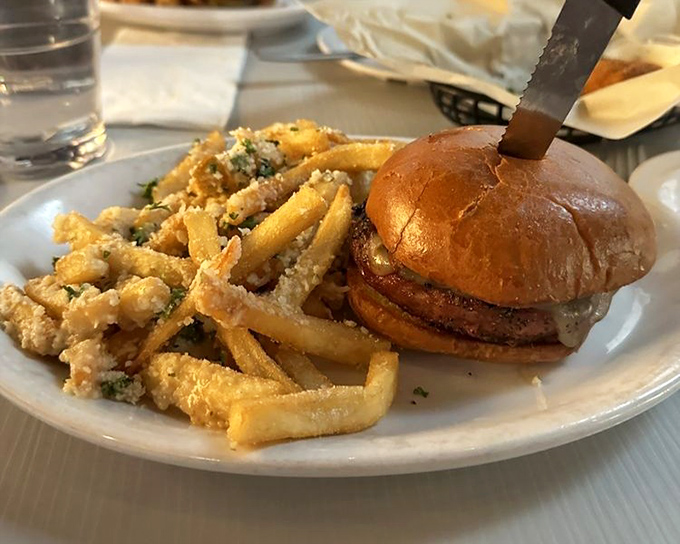A burger so perfectly composed it deserves its own Instagram account. Those parmesan fries aren't just a side dish – they're co-stars.