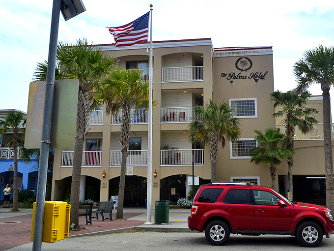 The Palms Hotel stands like a sentinel of summer memories, its balconies collecting ocean breezes and vacation stories.
