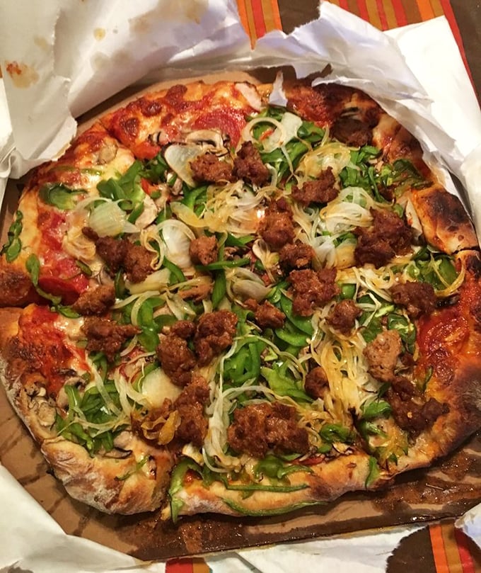 The famous "Vinnie Pie" in all its glory—where toppings aren't just added, they're celebrated in a carnival of flavor.