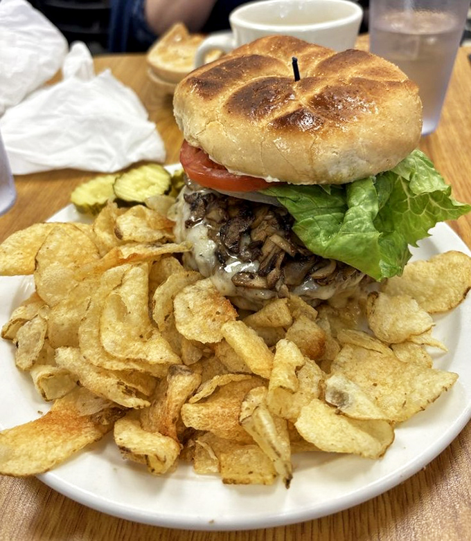This triple-stacked cheeseburger towers like a delicious skyscraper, challenging both appetite and jaw capacity.