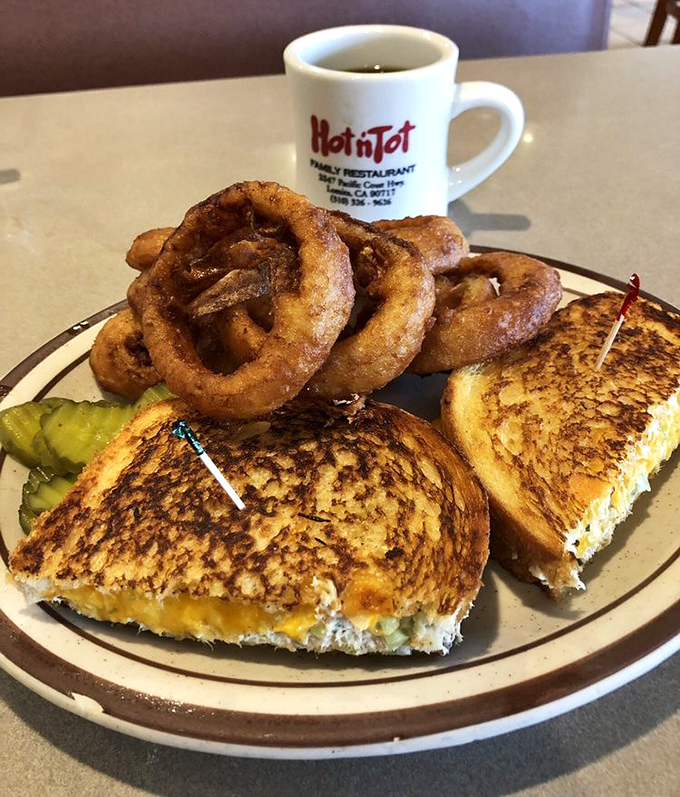 That grilled cheese and those onion rings aren't just lunch—they're comfort in edible form. The pickle is there to make you feel virtuous.