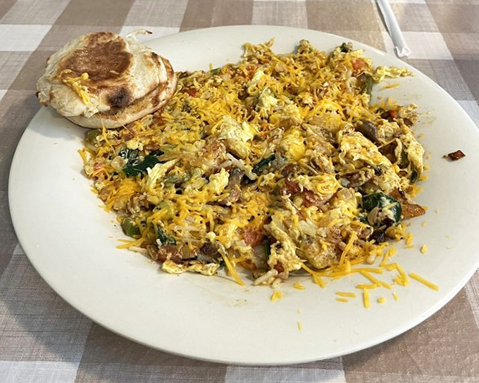Pink tablecloths and sage green walls create the perfect backdrop for morning conversations. Every plate that emerges from the kitchen is a conversation starter.