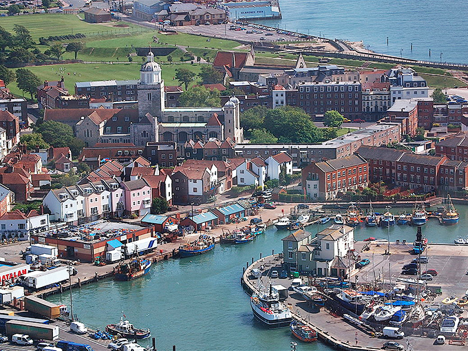 This aerial view reveals a charming harbor district where boats bob gently in protected waters—a scene more commonly associated with coastal towns than Ohio river communities.