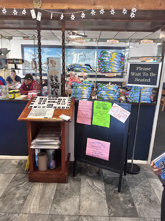 A "Please Wait To Be Seated" sign that's basically saying "Good things come to those who wait."