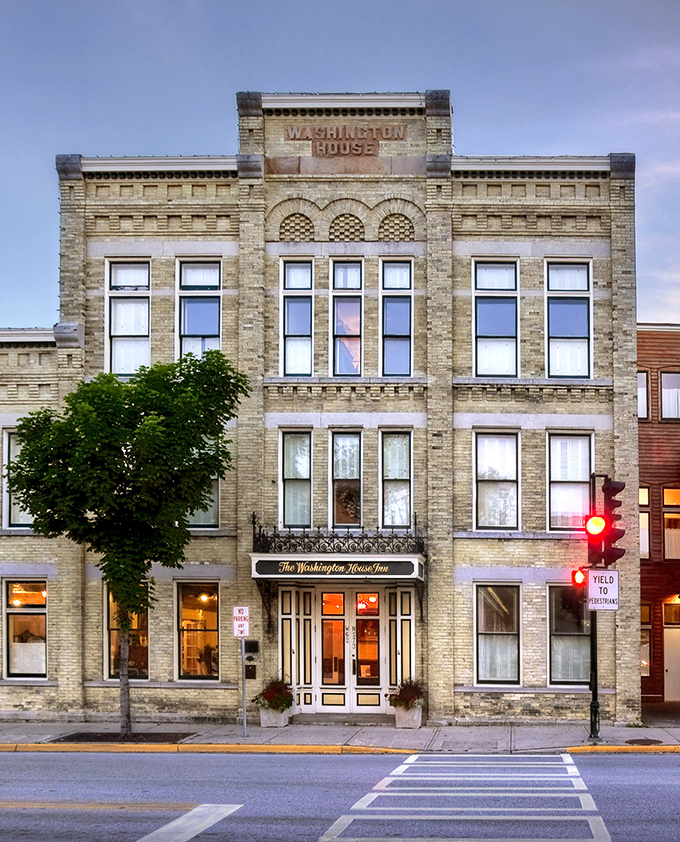 The Washington House Inn stands proudly on Washington Avenue, offering lodging with historic character that chain hotels try desperately to manufacture.