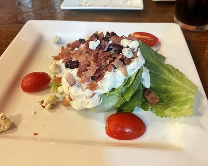 The wedge salad arrives like a cool, crisp island of lettuce in a sea of bacon bits and blue cheese—a classic done right.