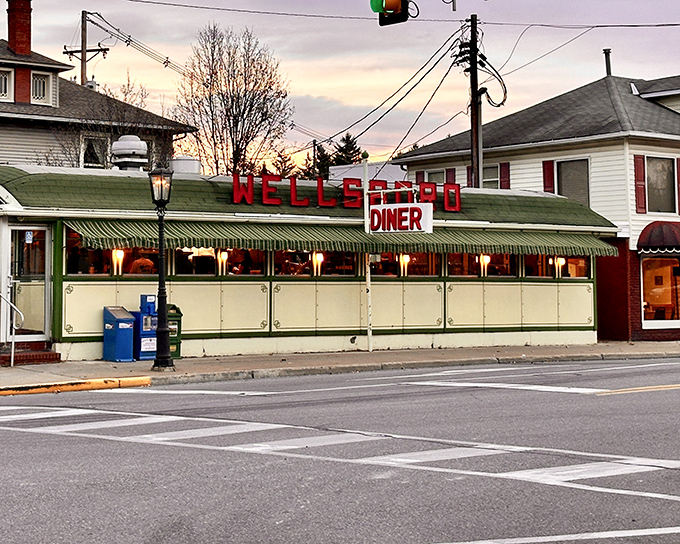 The iconic Wellsboro Diner glows at dusk, its vintage Sterling diner car design promising comfort food that transcends generations.