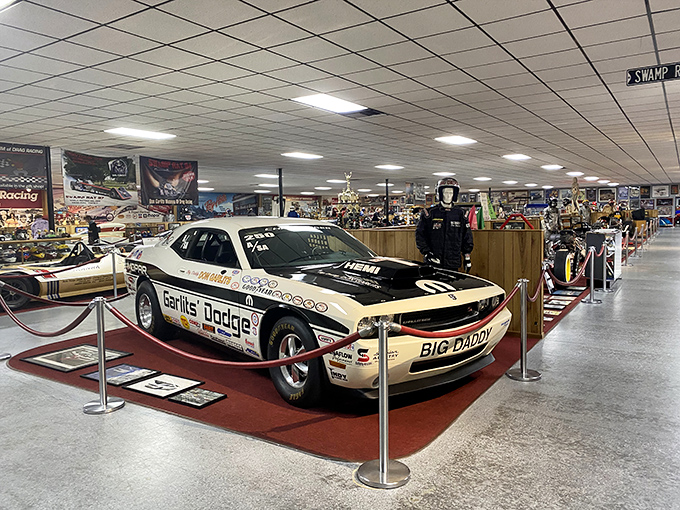 The "Fire Fly II" sits proudly among vintage automobiles. This white pioneer helped write drag racing history one quarter-mile at a time.