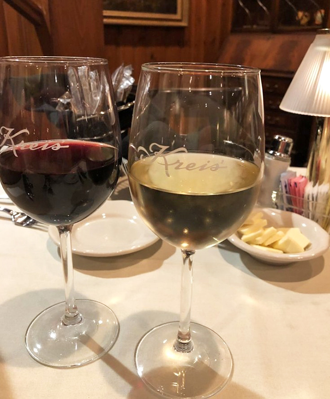Red and white wine in Kreis'-branded glasses—because proper glassware isn't just fancy, it's respect for what's inside.