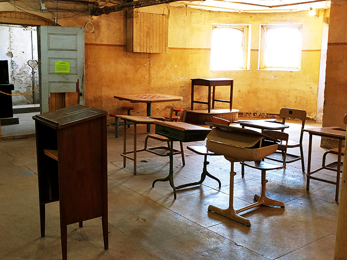 Abandoned desks frozen in time, waiting for students who will never return. Even detention seems preferable to this melancholy classroom.