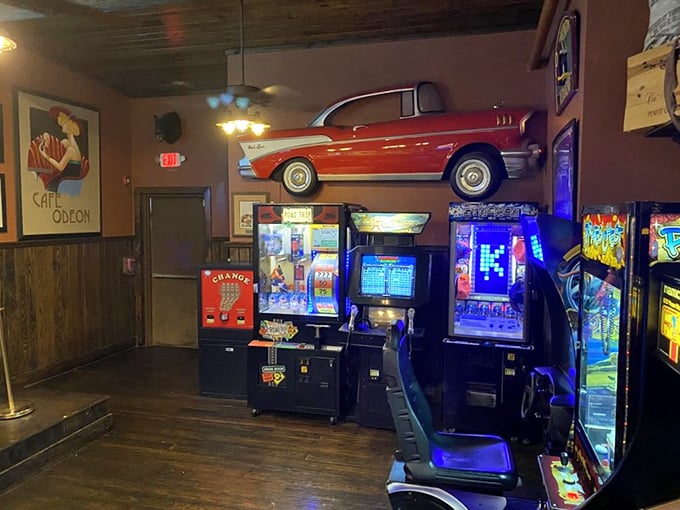 The arcade area offers a nostalgic break between crab courses. That vintage car on the wall has witnessed more food comas than a Thanksgiving dinner.