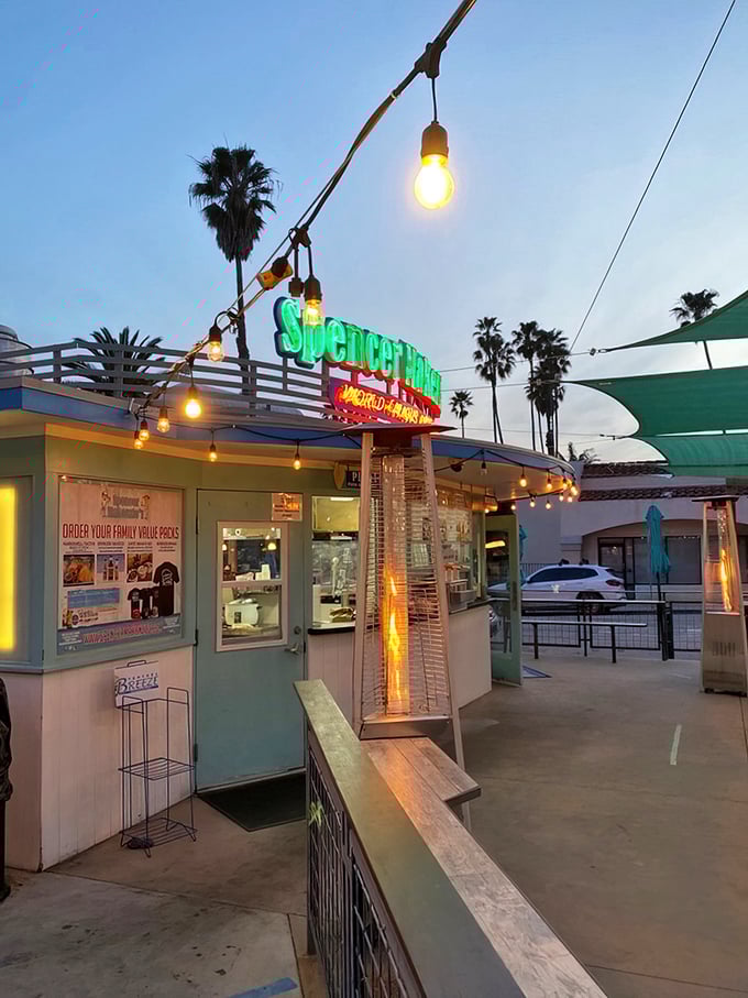 As dusk falls, the string lights transform this humble taco stand into a coastal wonderland where seafood dreams come true under palm tree silhouettes.