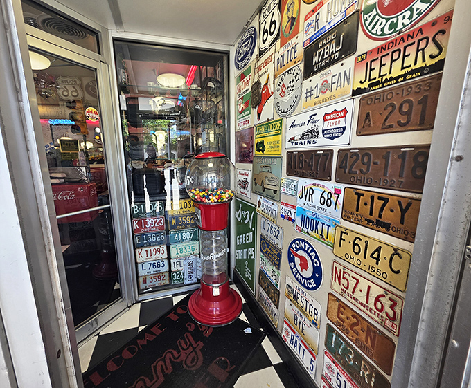 The entrance wall plastered with vintage license plates tells you everything: this place collects memories as eagerly as it serves breakfast.
