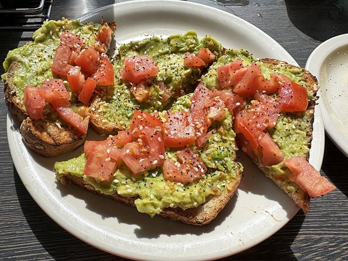 Avocado toast that doesn't require a second mortgage &ndash; just fresh avocado, diced tomatoes, and everything bagel seasoning on hearty bread.