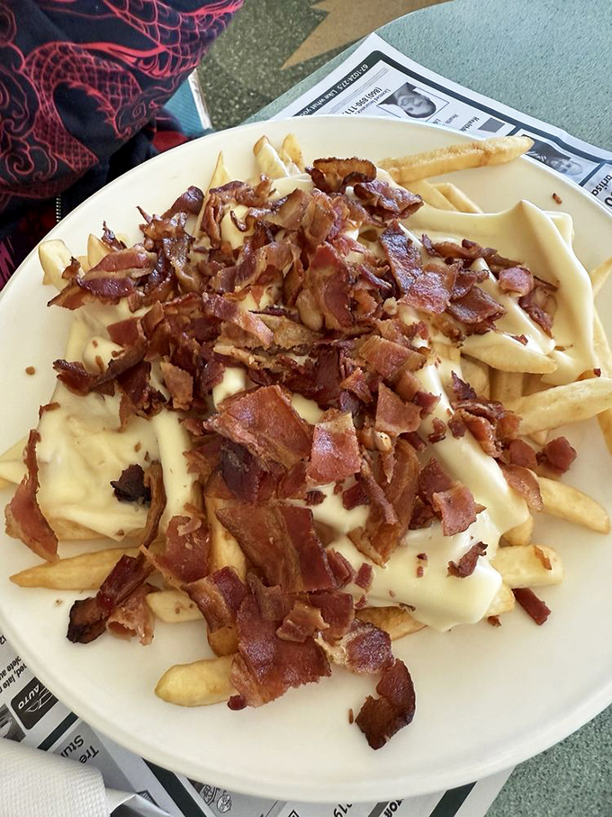 Cheese fries with bacon bits—because sometimes adulting means eating whatever makes you happy. Diet culture can send its complaints to the circular file.