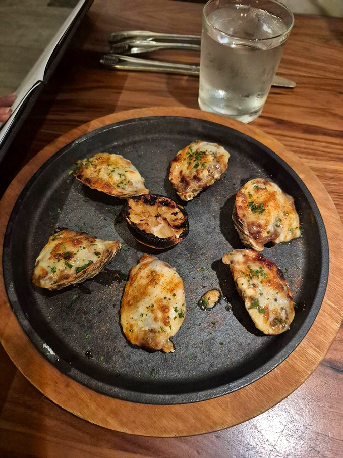 Oysters wearing their Sunday best. These baked beauties are dressed in cheese and herbs, making the raw bar suddenly seem underdressed.