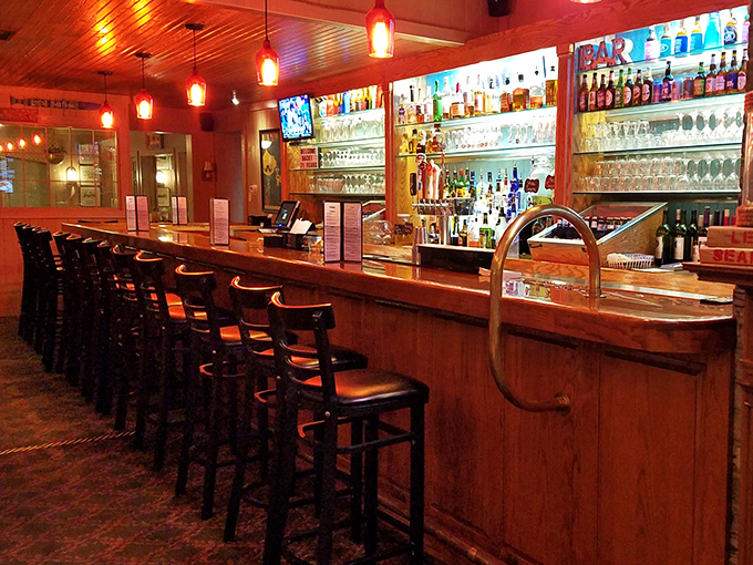 A bar that beckons with amber lighting and the promise of perfectly mixed drinks to complement your seafood feast.