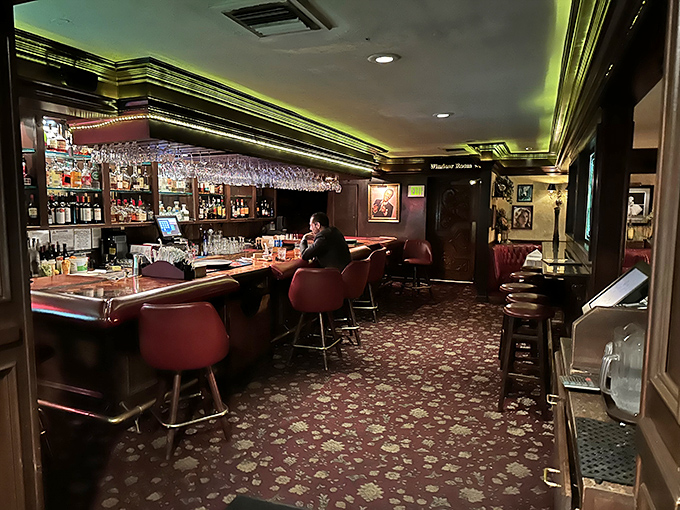 The bar glows with amber promise, wine glasses hanging like crystal stalactites. A sanctuary where day's troubles dissolve in good spirits.