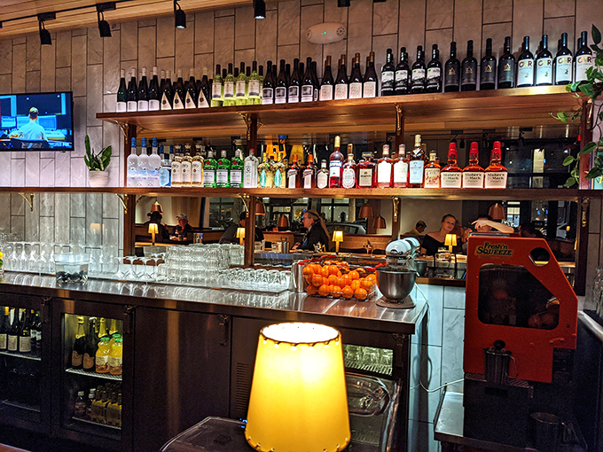 A bar stocked for serious business. Those bottles aren't just decoration—they're possibilities waiting to complement whatever you're ordering.