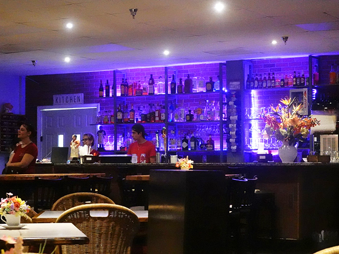That purple-lit bar glows like a jewel box filled with liquid treasures and endless possibilities.
