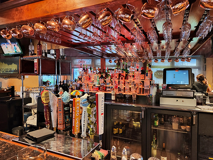 The impressive bar showcases extensive selections, creating a backdrop for memorable evenings filled with exceptional drinks and great conversation.
