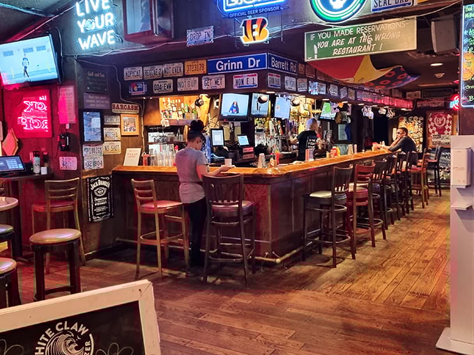 The bar area—where license plates meet neon signs and strangers become friends over shared stories and cold beverages.