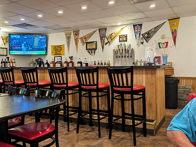 The bar area, complete with Pittsburgh sports memorabilia, is where locals debate the Steelers' chances while awaiting their pies.