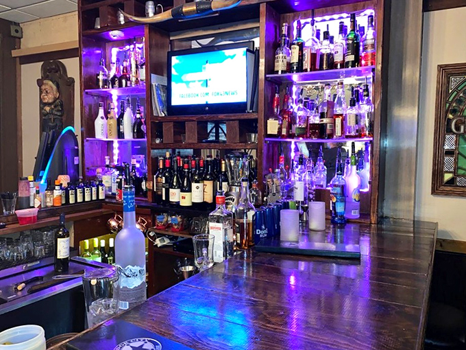 The bar gleams with purple-lit bottles, promising libations that pair perfectly with whatever cut of beef you've selected.