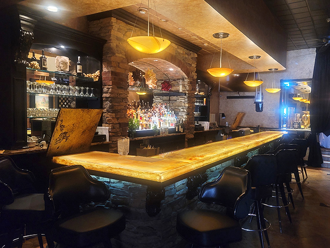 The bar isn't just a place to wait for your table &ndash; it's a destination itself, with its golden glow and stone accents inviting lingering conversations.