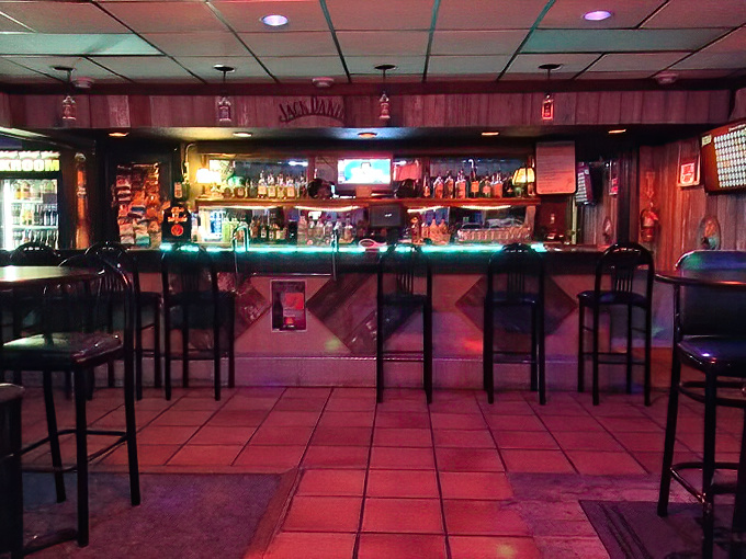 Where spirits meet spirited conversation. The bar area glows with the promise of cold drinks and warm welcomes.