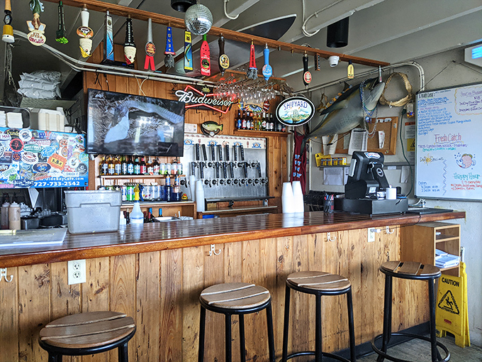 The bar's weathered wood and nautical touches aren't manufactured charm&mdash;this is authentic Florida, where beer taps and fishing tales flow freely.