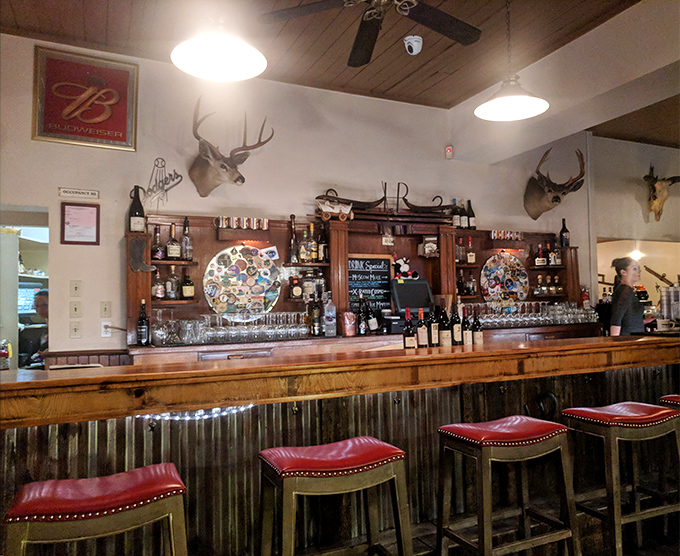 The bar&mdash;where cocktails are mixed with confidence and wine glasses await their moment. Those red leather stools have supported generations of happy diners.
