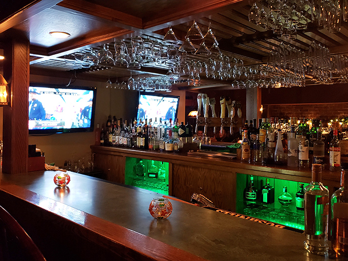 A bar stocked for serious business, with hanging glassware that catches the light like crystal chandeliers for the cocktail crowd.