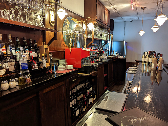 The bar area balances old-world charm with modern efficiency, where Italian wines await their moment to shine.