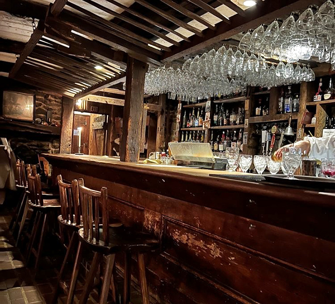 The bar where spirits meet spirits&mdash;colonial craftsmanship meets modern mixology under a canopy of gleaming glassware.