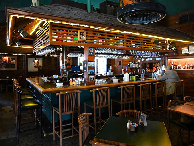 The bar area glows with warm wood and soft lighting, creating the perfect backdrop for seafood stories and second rounds of whatever you're having.