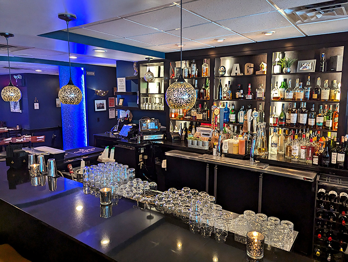 The well-stocked bar area features modern lighting and enough spirits to satisfy any discerning palate.