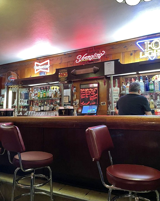 The bar area glows with neon signs and decades of stories, where locals gather for pre-dinner drinks and post-meal digestifs.