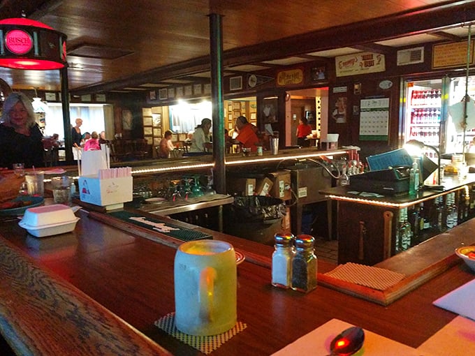 The bar area glows with the warm promise of good drinks and better conversation. Wood-paneled nostalgia never goes out of style.