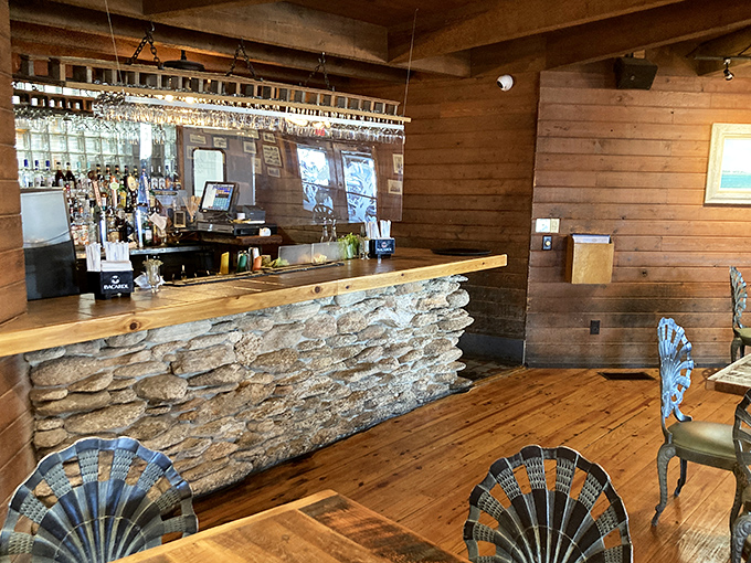 A bar crafted from stone and wood that looks like it washed ashore from Atlantis, serving drinks with views to match.