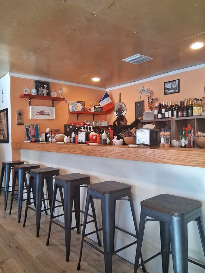 The counter offers front-row seats to the culinary action, where coffee machines hiss and pastries await their moment of glory.