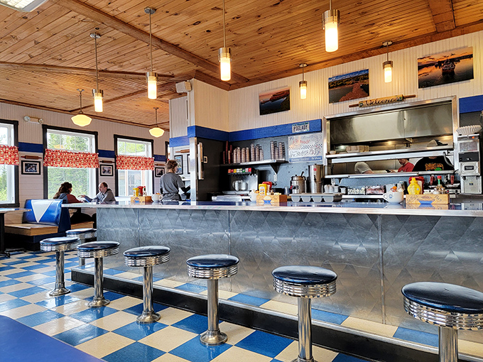 The counter where magic happens&mdash;stainless steel gleaming under wooden ceilings, promising delicious possibilities with every order placed.
