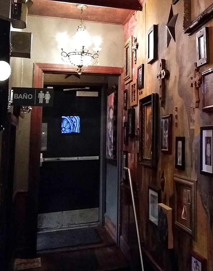 Even the hallway to the restrooms tells a story, with walls adorned in framed art and that unmistakable "Ba&ntilde;o" sign pointing the way.