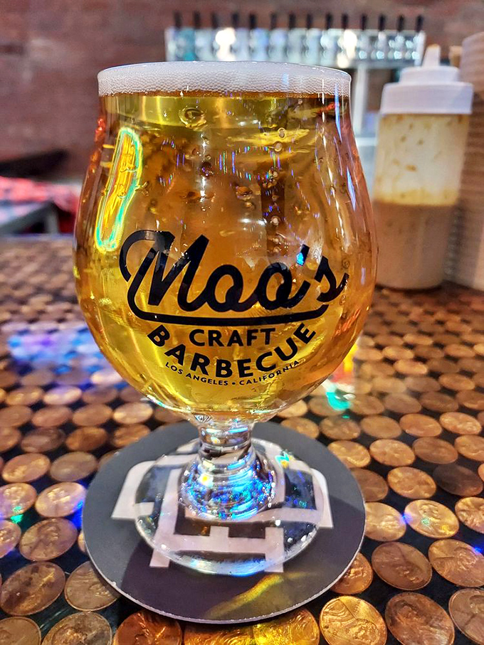 Beer served in a glass that curves like a smile, because your taste buds are about to have a very good day at Moo's Craft Barbecue.