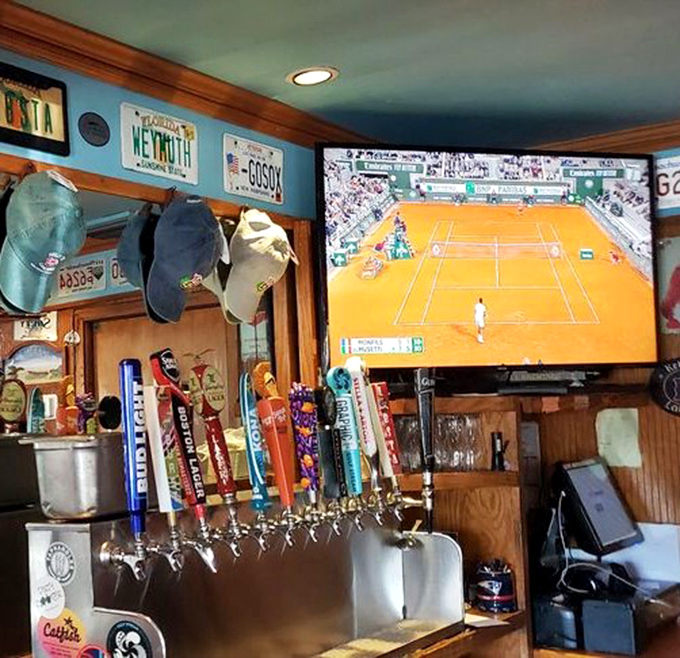 The bar area showcases Boston sports pride alongside an impressive tap selection. You're in Patriots Country now, even in Dolphins territory.