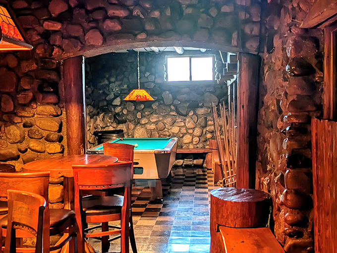 Stone-walled game room offers entertainment between courses, adding playful elements to your memorable dining experience here.